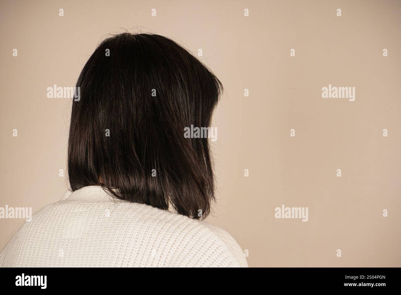 The black bob is neatly flowing when viewed from behind, showcasing its ...