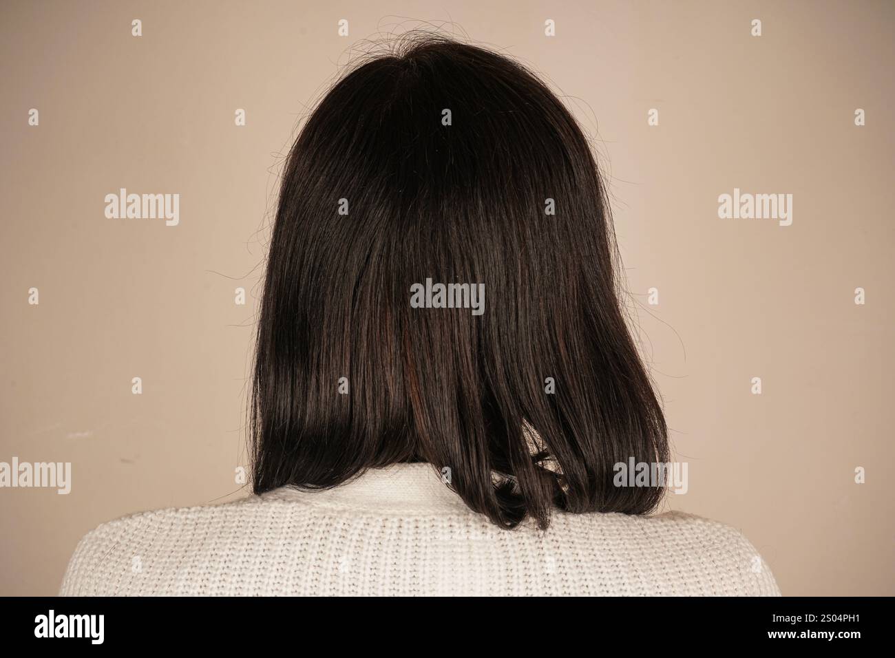 The black bob is neatly flowing when viewed from behind, showcasing its ...