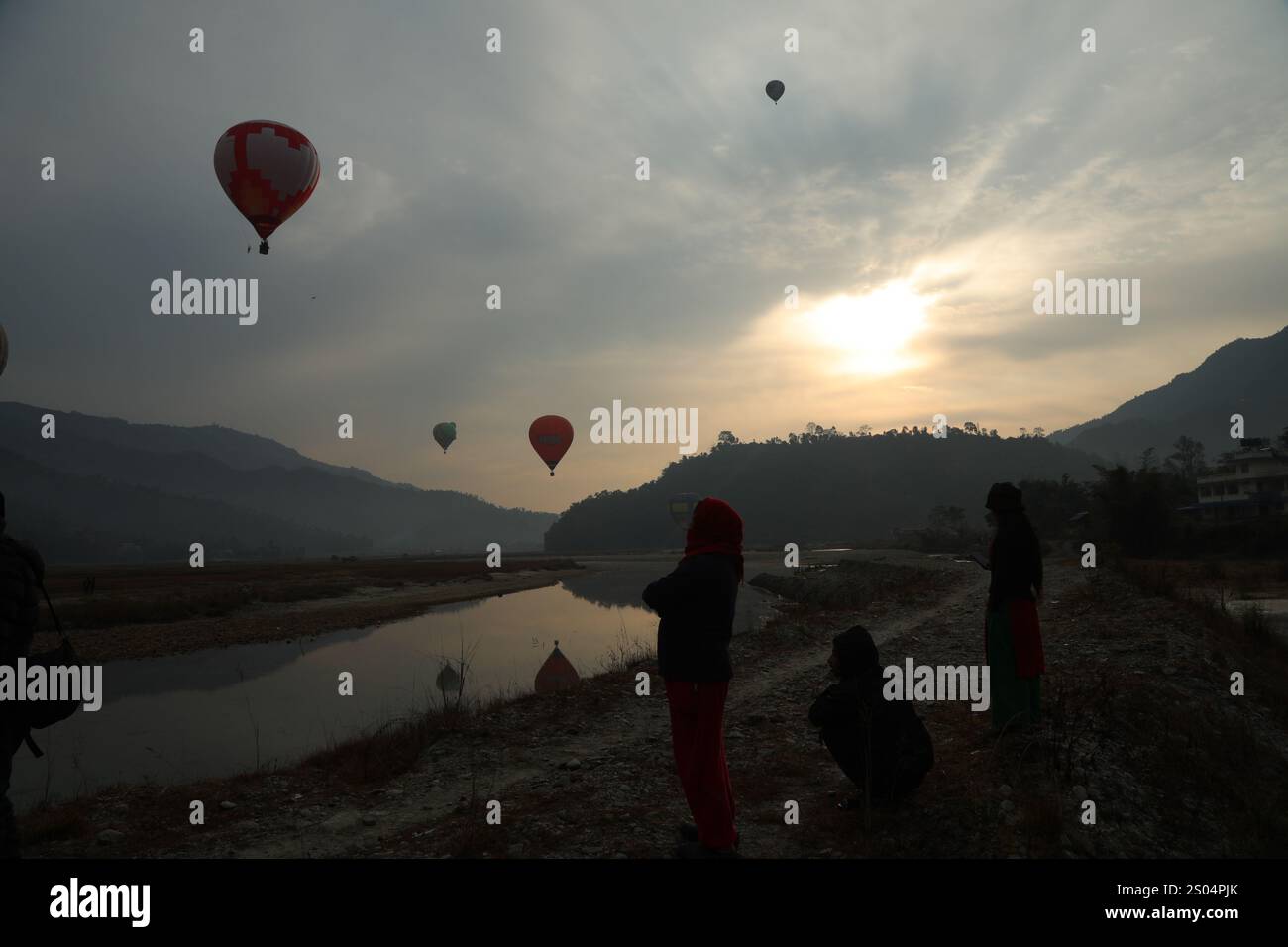 Pokhara, Nepal. 24th Dec, 2024. Local people enjoy as hot air balloons ...