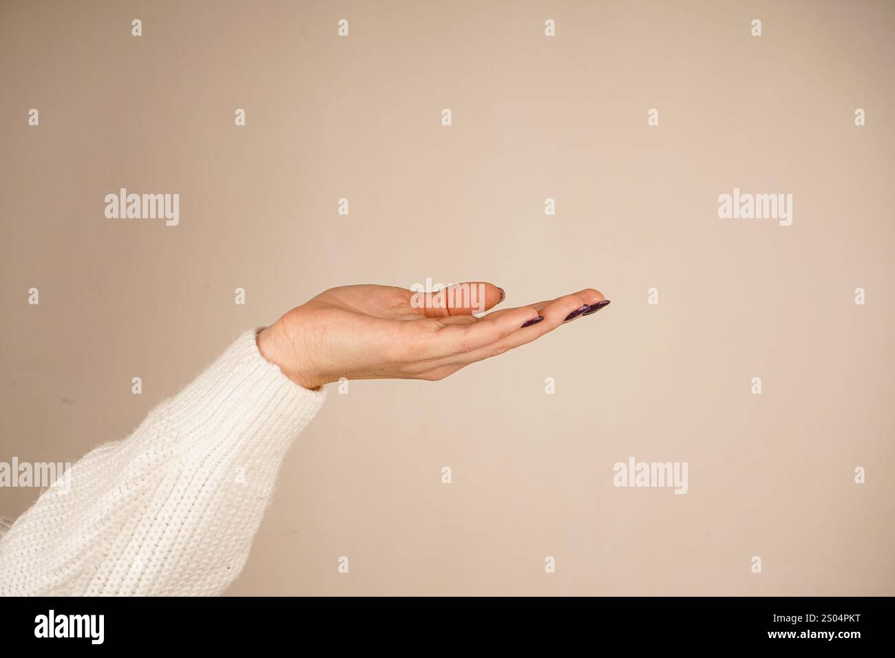 A single hand with an open palm faces upward, creating a gesture of ...
