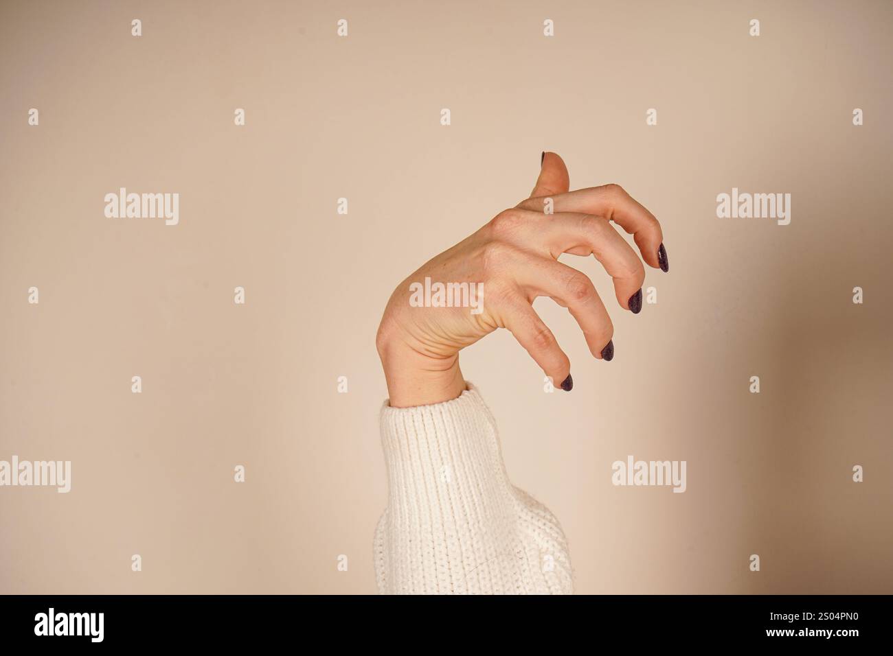 The hand is shaped like a cat's paw with fingers bent and spread ...