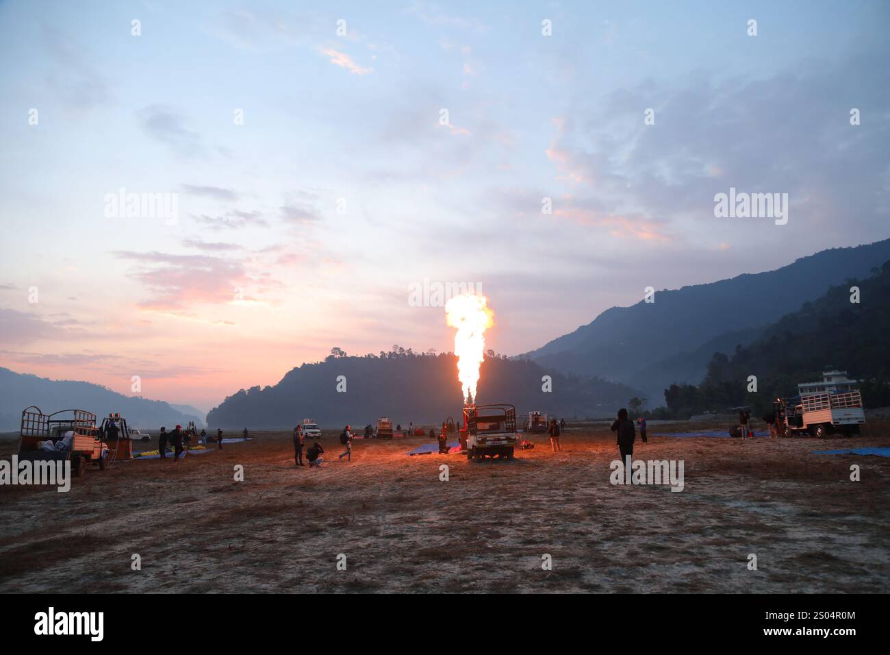 Crew members prepare their hot air balloon to be rised in the sky of ...