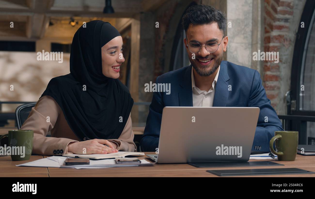 Two business colleagues co-workers talk discuss corporate work at ...