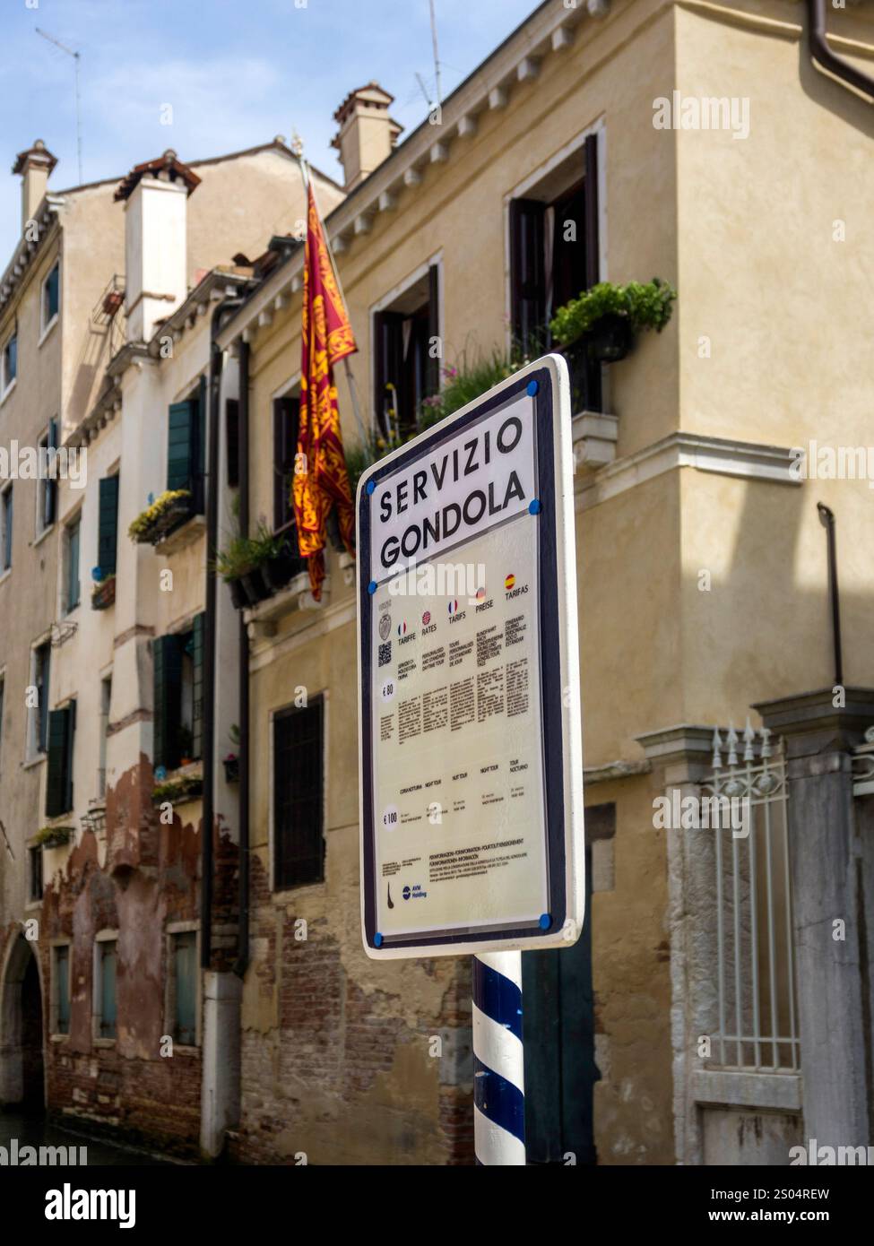VENICE, ITALY - MAY 05, 2015: Gondola Service sign on small canal with ...