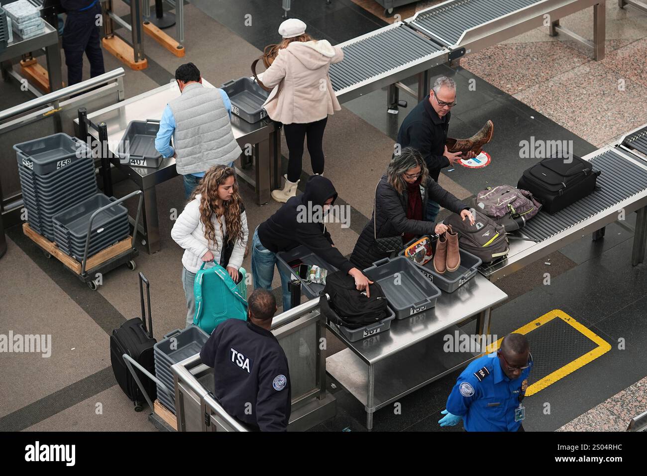 Travellers queue up to pass through the south security checkpoint in ...