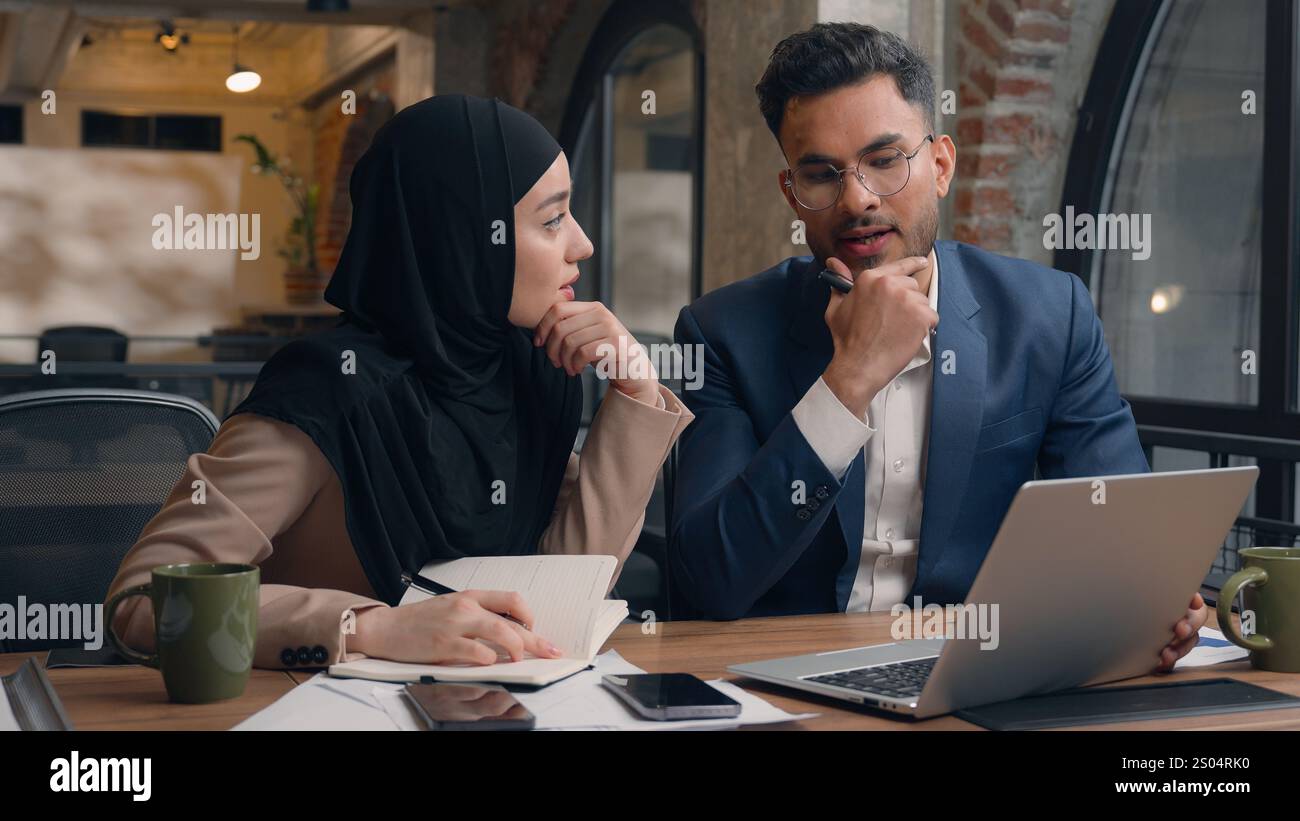 Two business colleagues co-workers talk discuss corporate work at ...