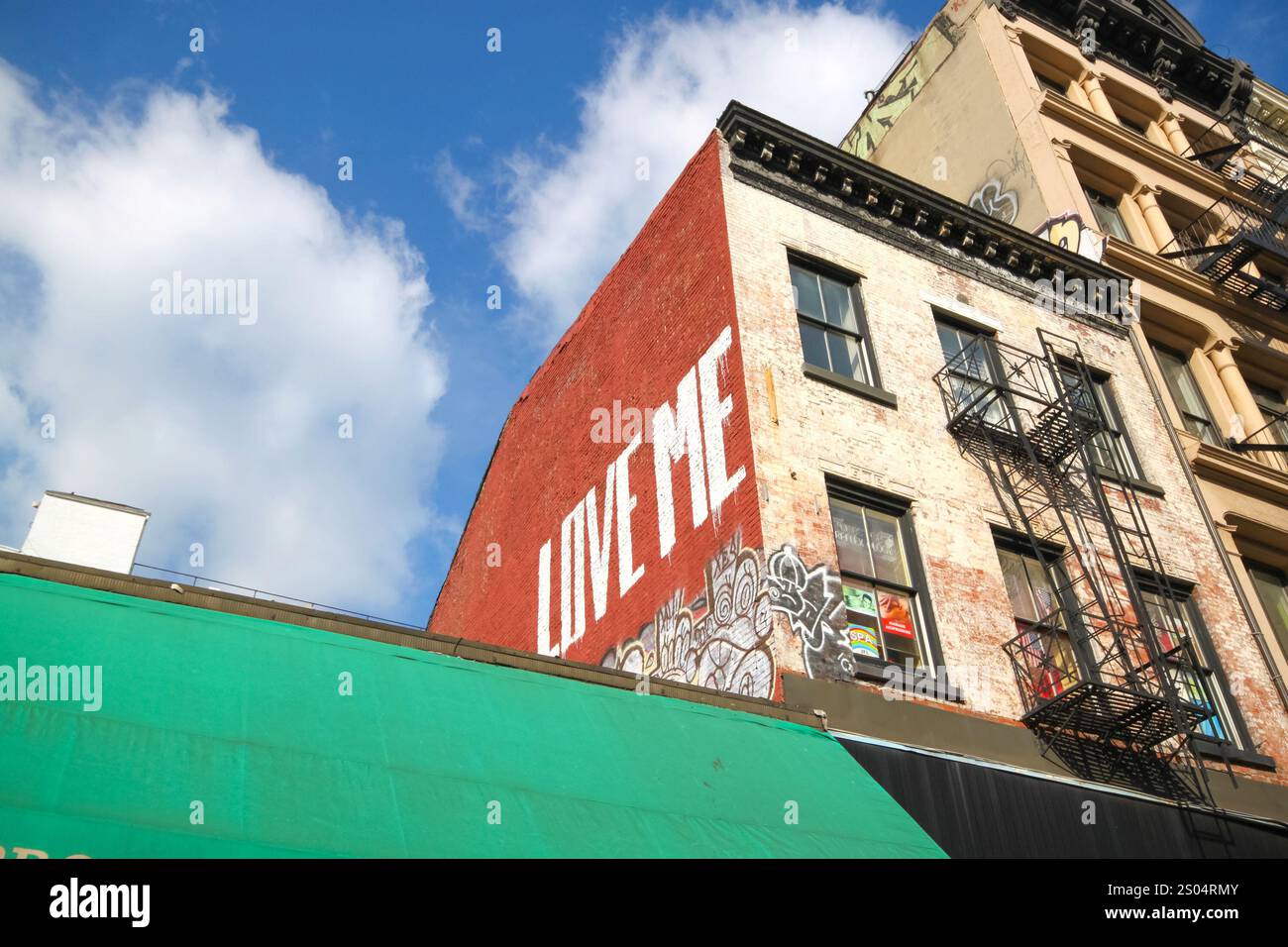 new york city Urban scene with a brick building featuring "love me ...