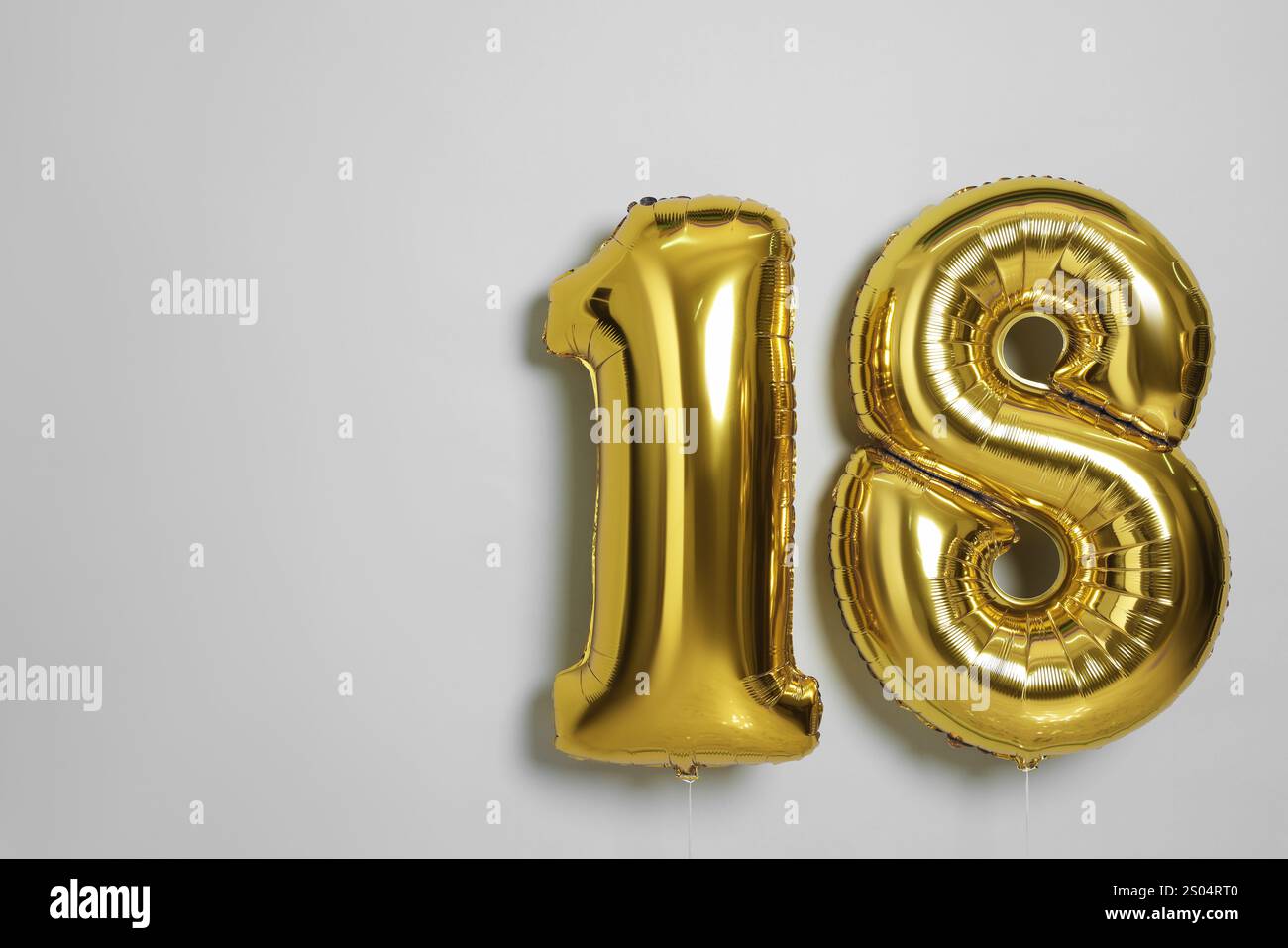 Coming of age party - 18th birthday. Number shaped balloons on light ...