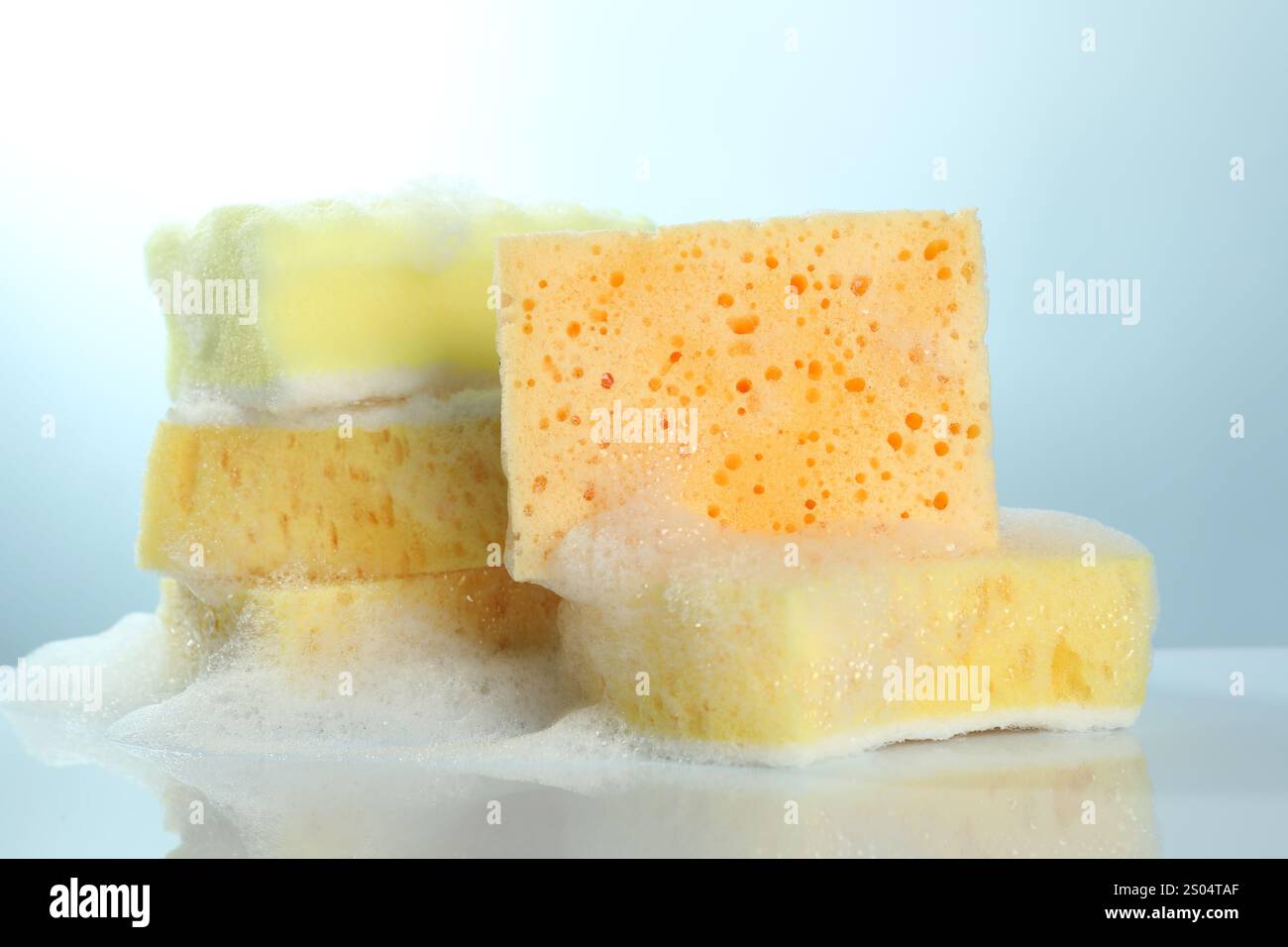 Sponges with foam on light table, closeup Stock Photo - Alamy