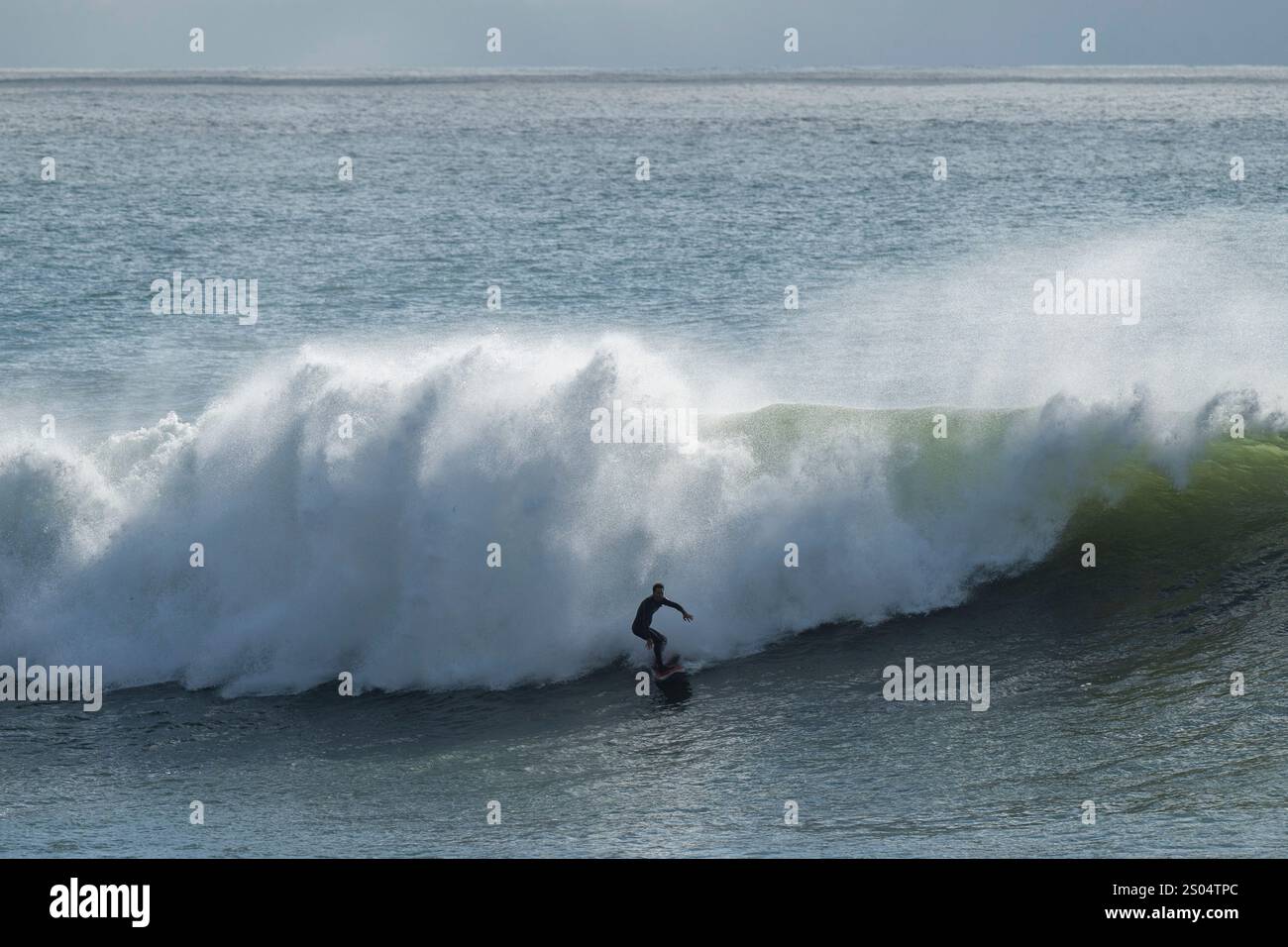 A surfer rides a large wave at Steamer Lane in Santa Cruz, Calif ...