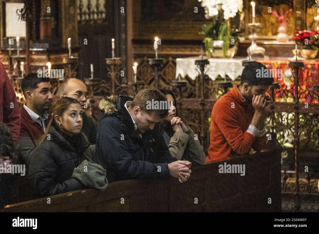 AMSTERDAM - Churchgoers during a moment of reflection during Midnight ...
