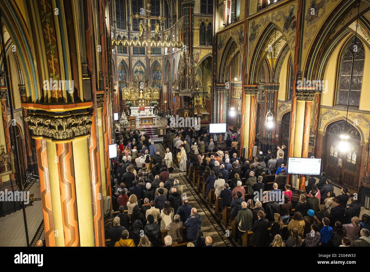 AMSTERDAM - Churchgoers during a moment of reflection during Midnight ...