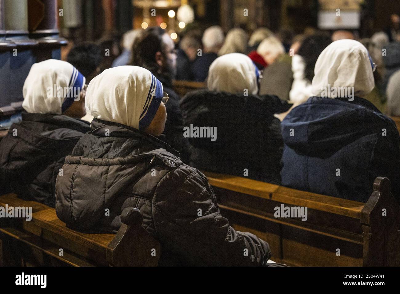 AMSTERDAM - Churchgoers during a moment of reflection during Midnight ...