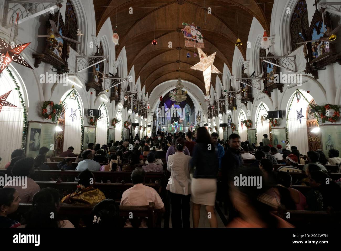 Christians attend a midnight Christmas Mass at Santhome Cathedral ...