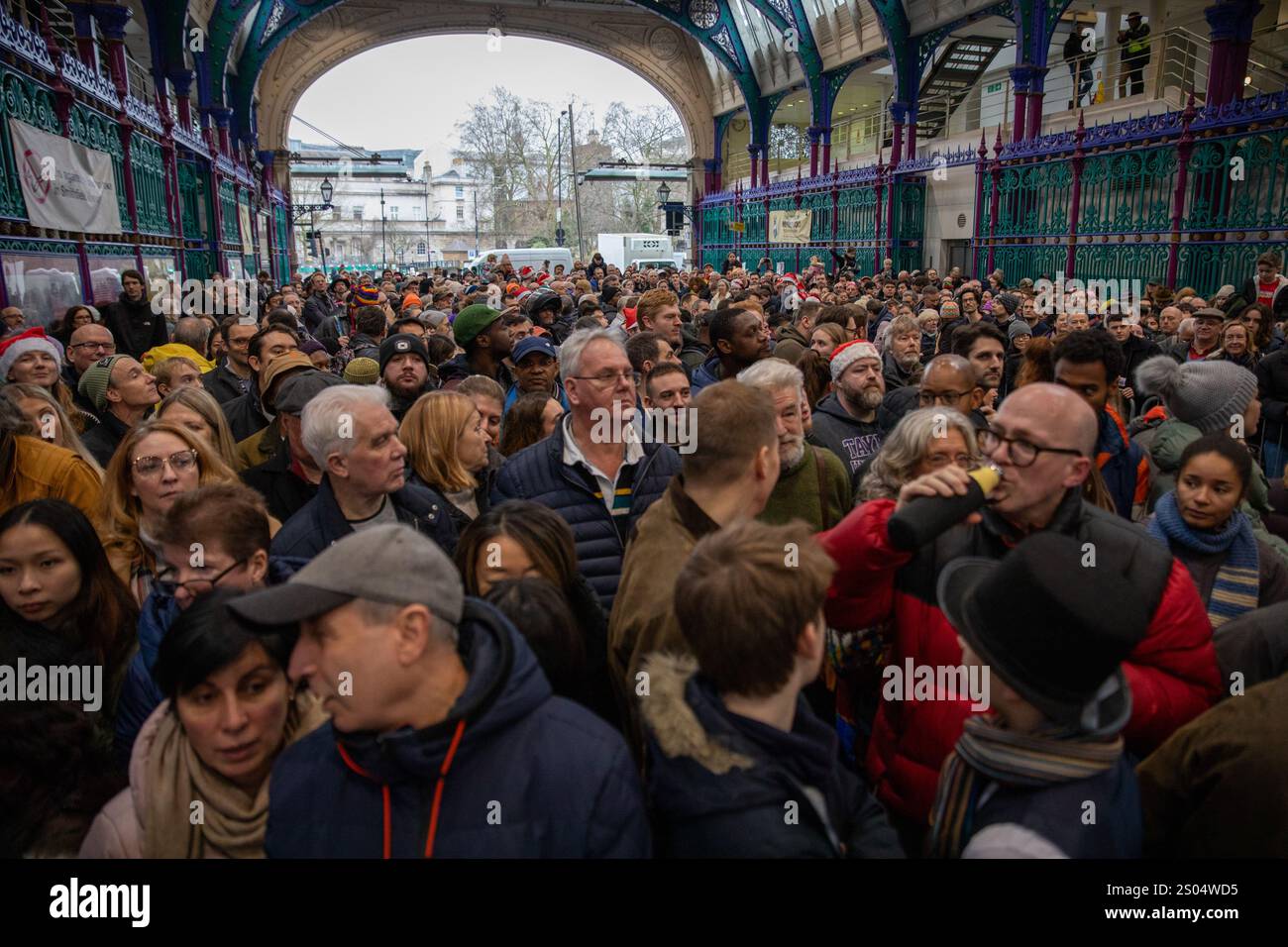A crowd gathers at a Christmas meat auction. In a tradition that is ...