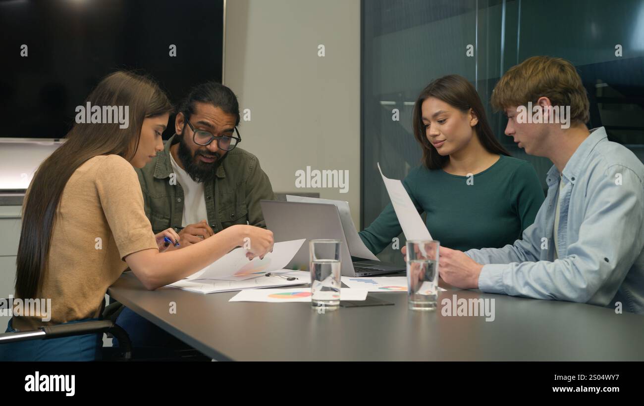 Diverse businessmen businesswomen team review sales data documents ...