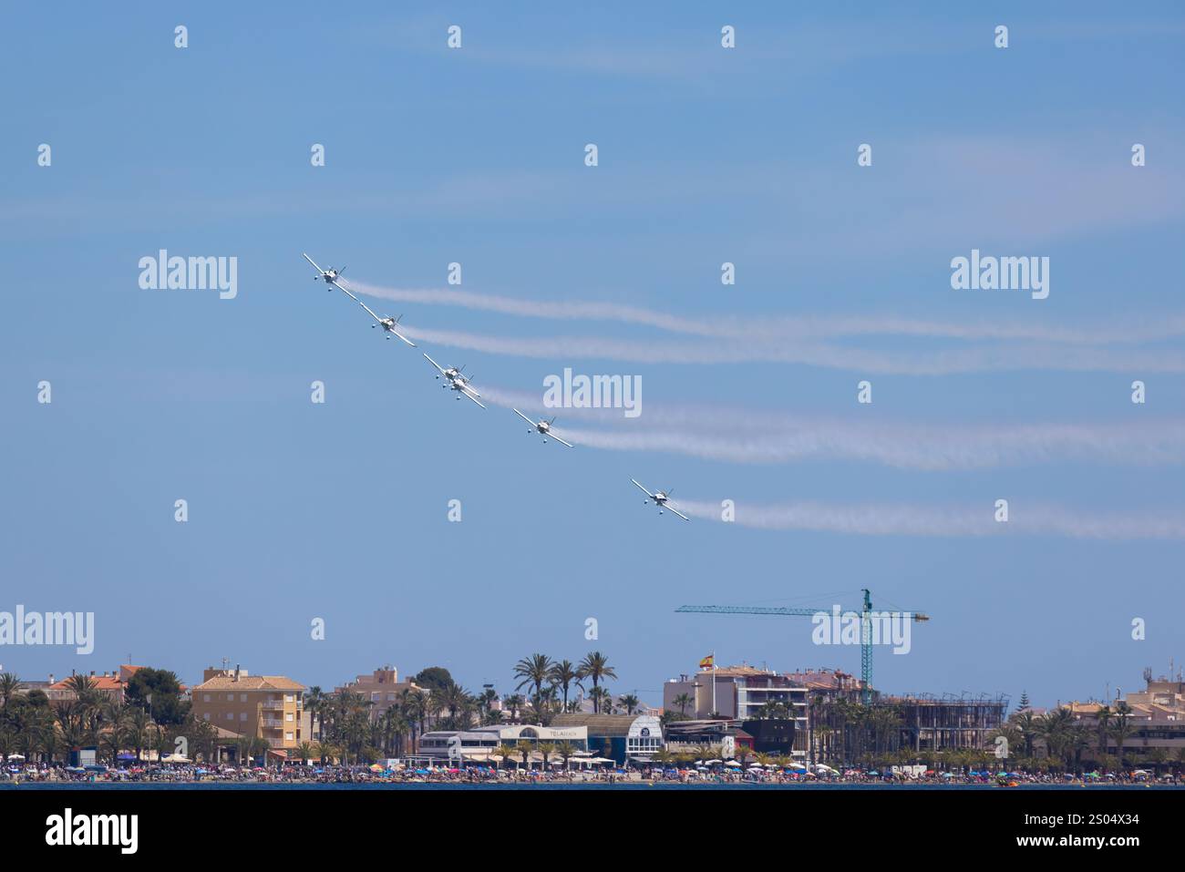 A formation of aircraft performs a synchronized aerial display over the ...