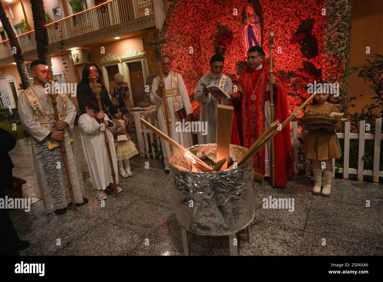 Iraqi Christians attend a Christmas Eve mass at the Sacred Heart Church ...