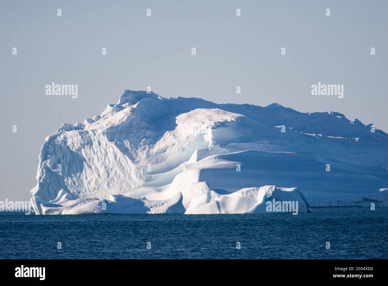This striking image showcases a magnificent iceberg floating in the ...