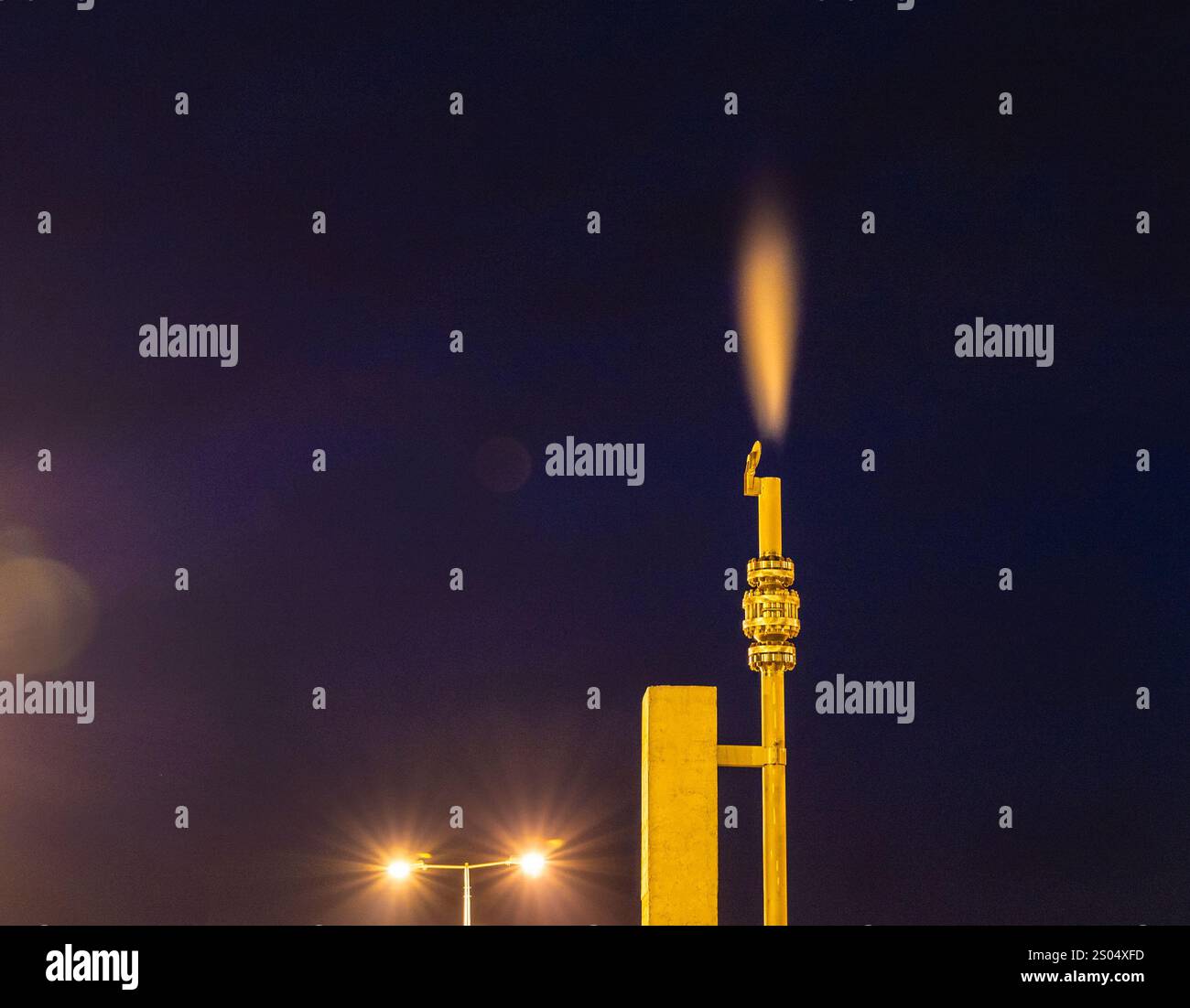 Gas venting during pipeline maintenance captured at night with a flare ...