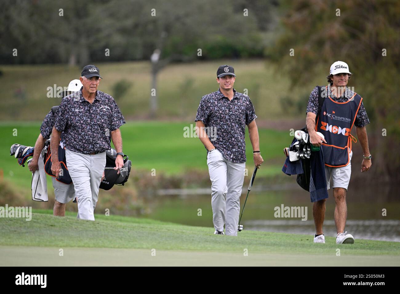 Tom Lehman walks to the 17th green with his sons Sean Lehman, center ...