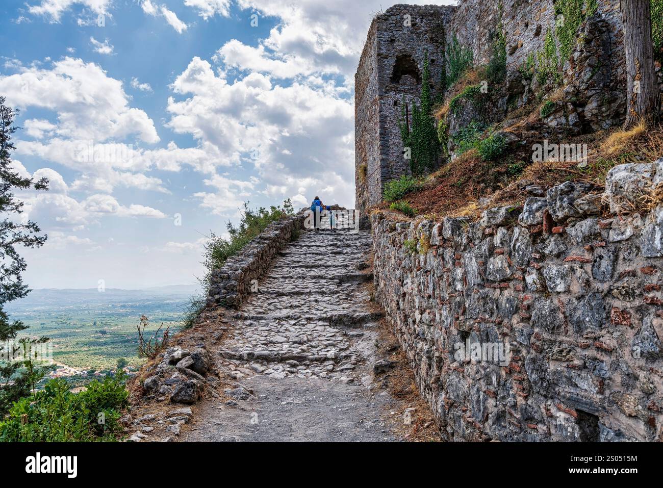 A stone-paved pathway ascending to the fortress walls in Mystras ...