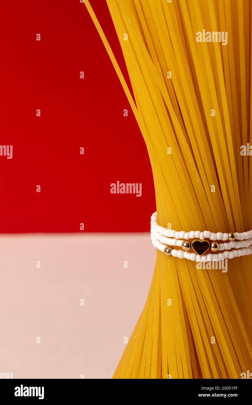 Spaghetti wrapped in a white pearl necklace close-up Stock Photo - Alamy
