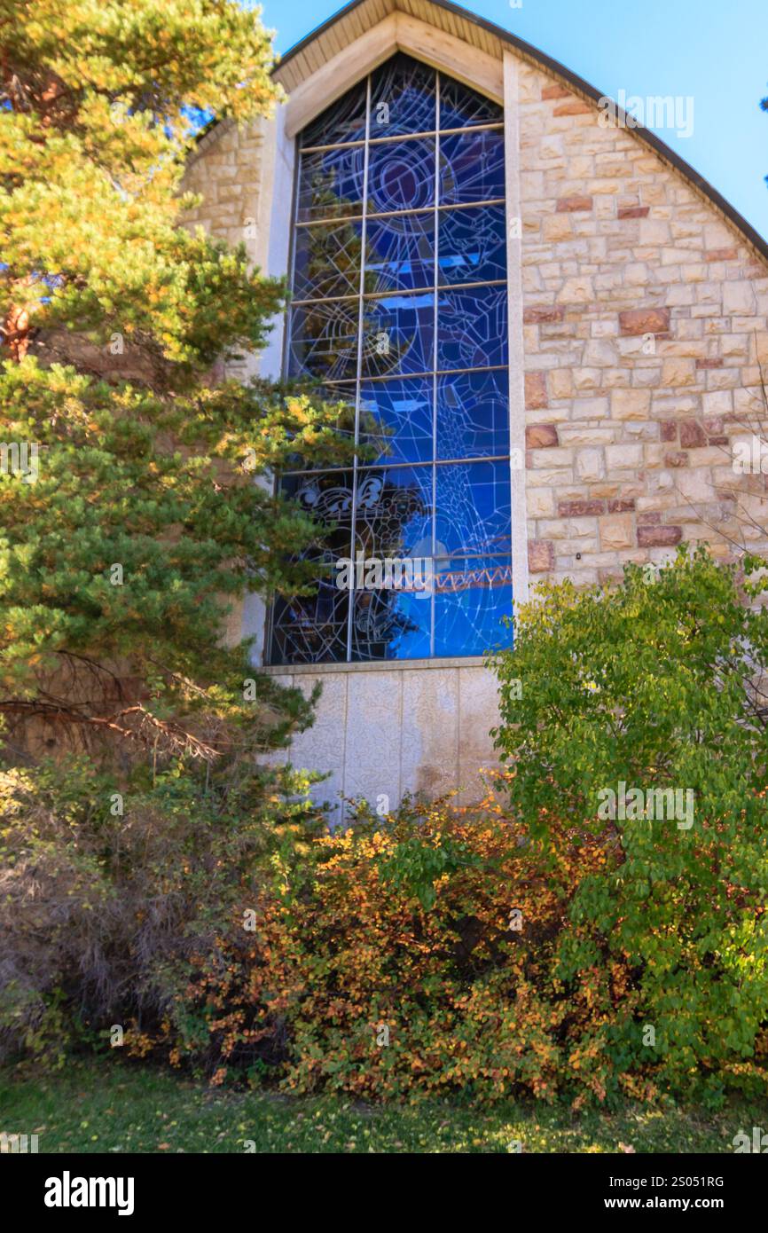 A church steeple with stained glass windows and a large window. The ...