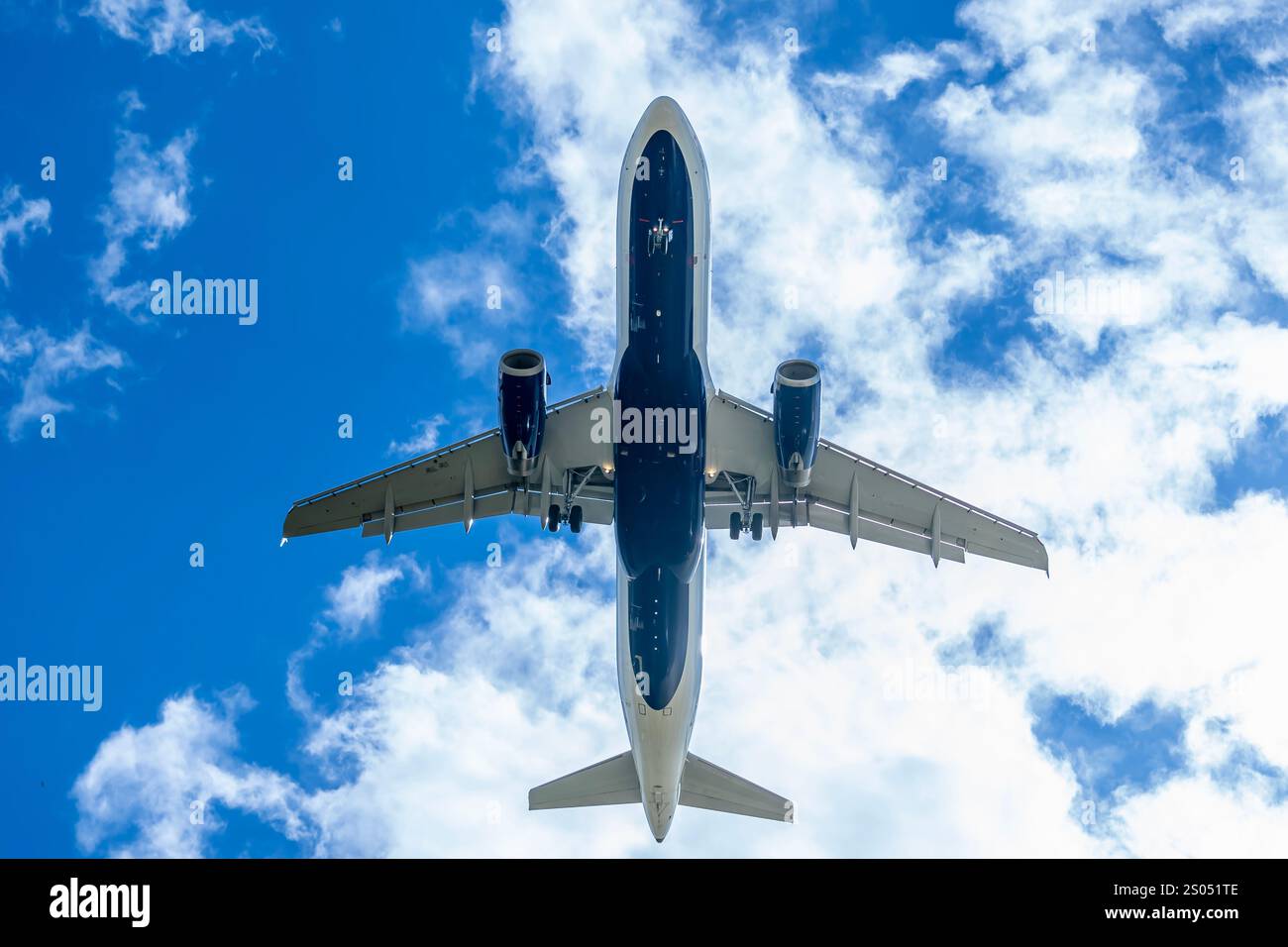 A sleek commercial jet aligns on final approach at a bustling airport ...