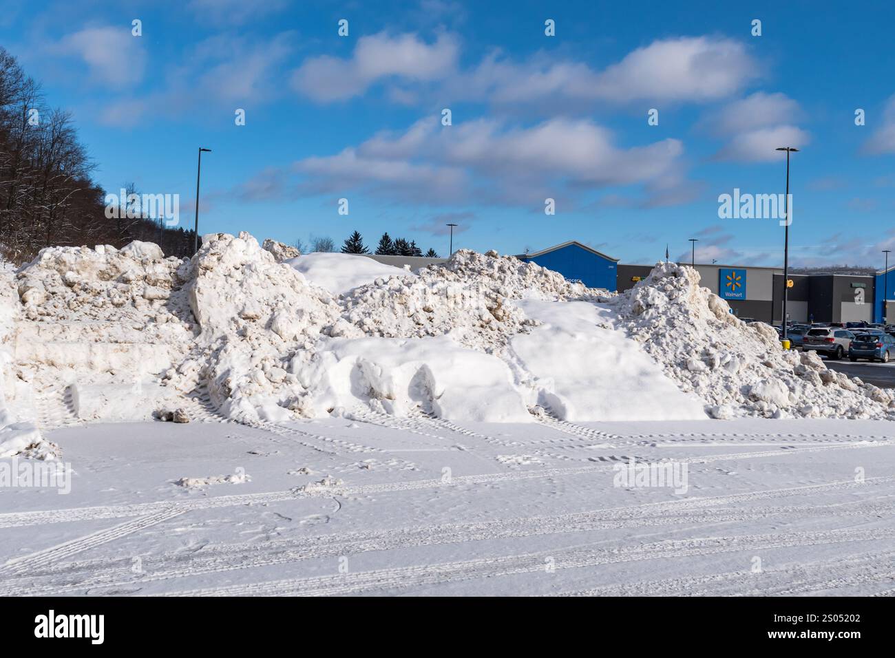 A large pile of plowed snow in a Walmart parking lot in Conewango ...