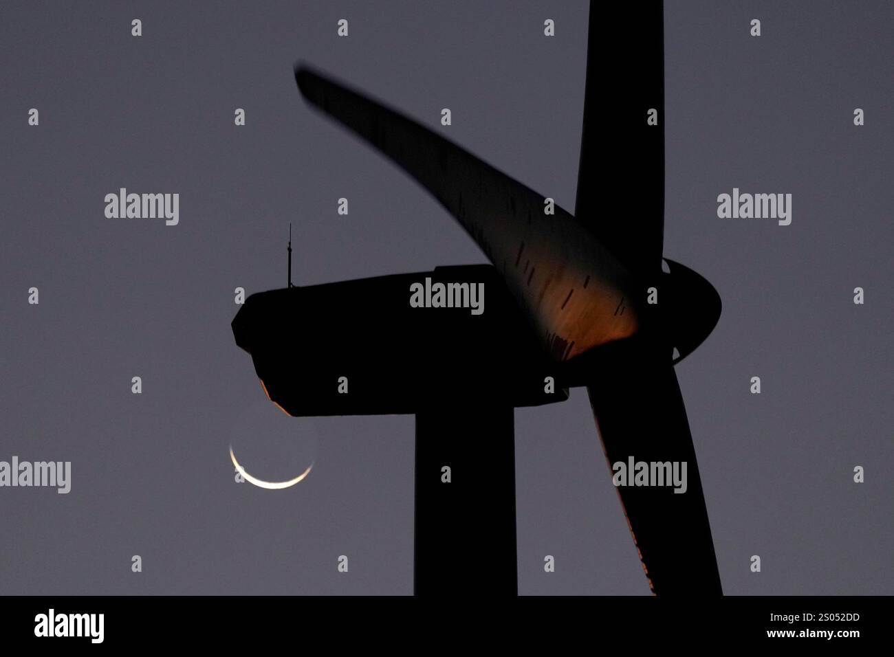The crescent moon rises behind a wind turbine at the Buckeye Wind ...
