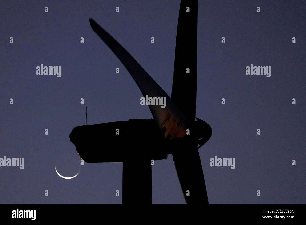 The crescent moon rises behind a wind turbine at the Buckeye Wind ...