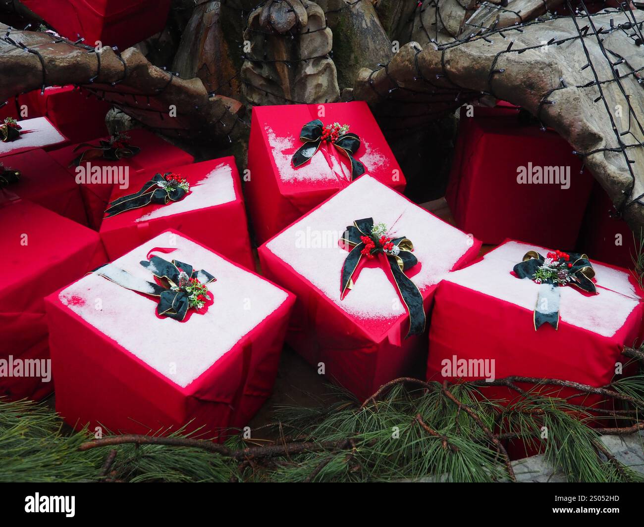 Large red gift boxes with elegant black ribbons and floral accents are ...