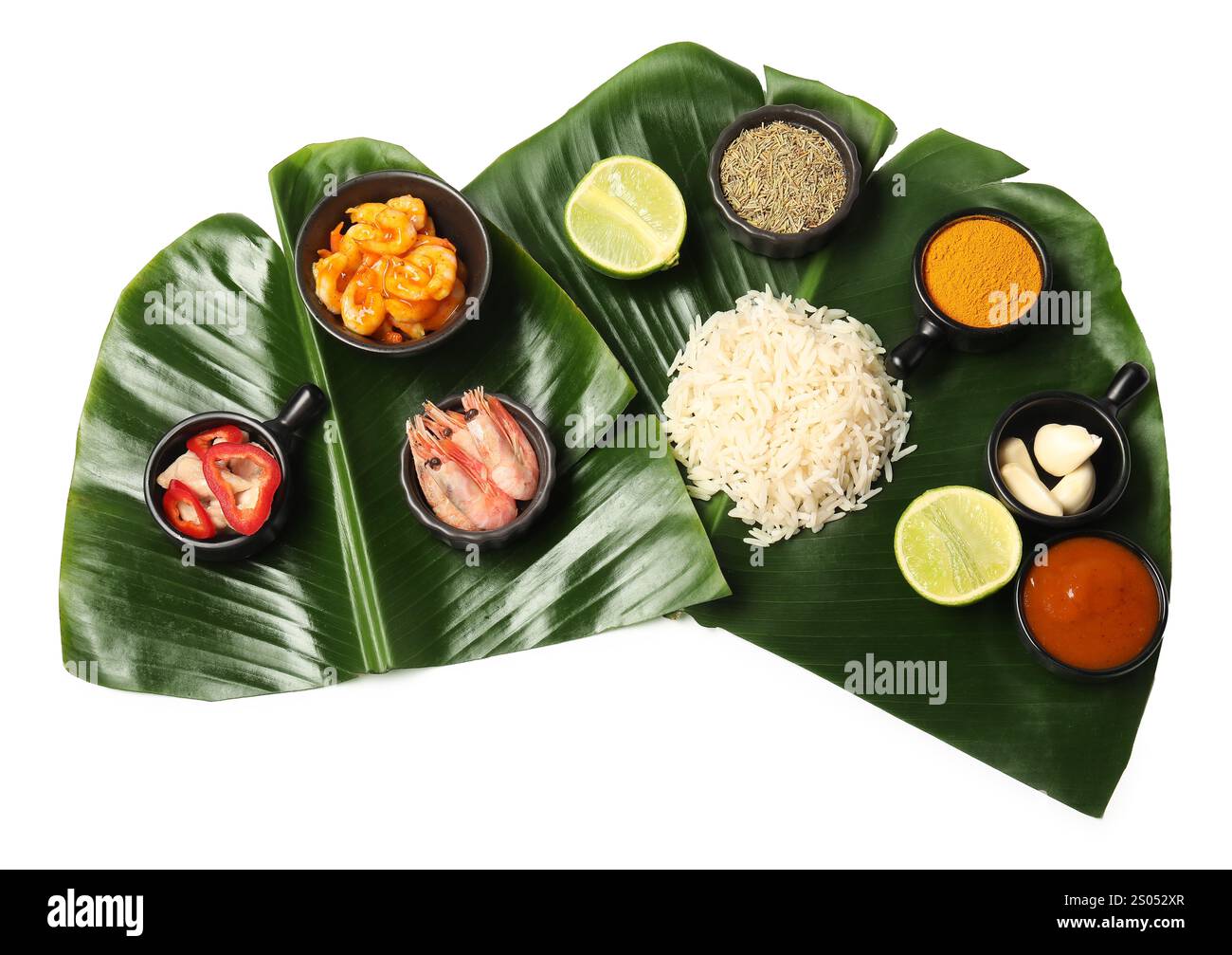 Cut banana leaves with different food, spices and sauce isolated on ...