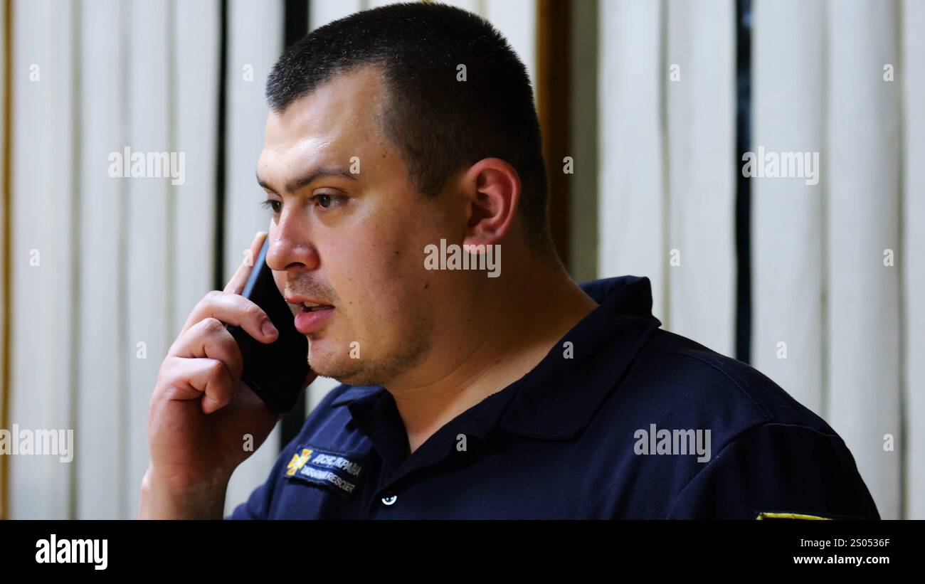 Male firefighter chief have serious telephone conversation with his ...