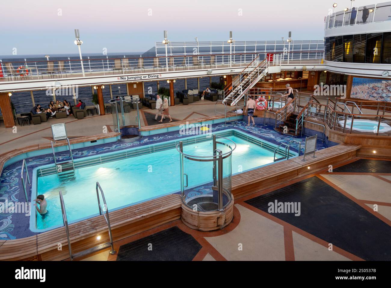 Cunard Queen Elizabeth cruise ship sailing at dusk sunset with people ...