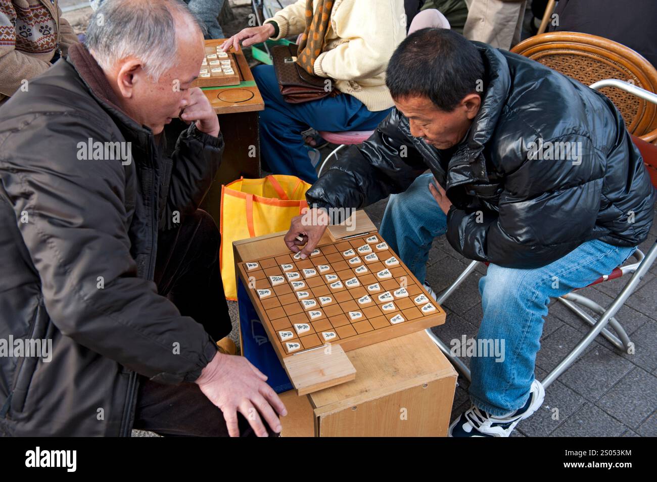 Competitors challenging each other to a strategy board game called ...