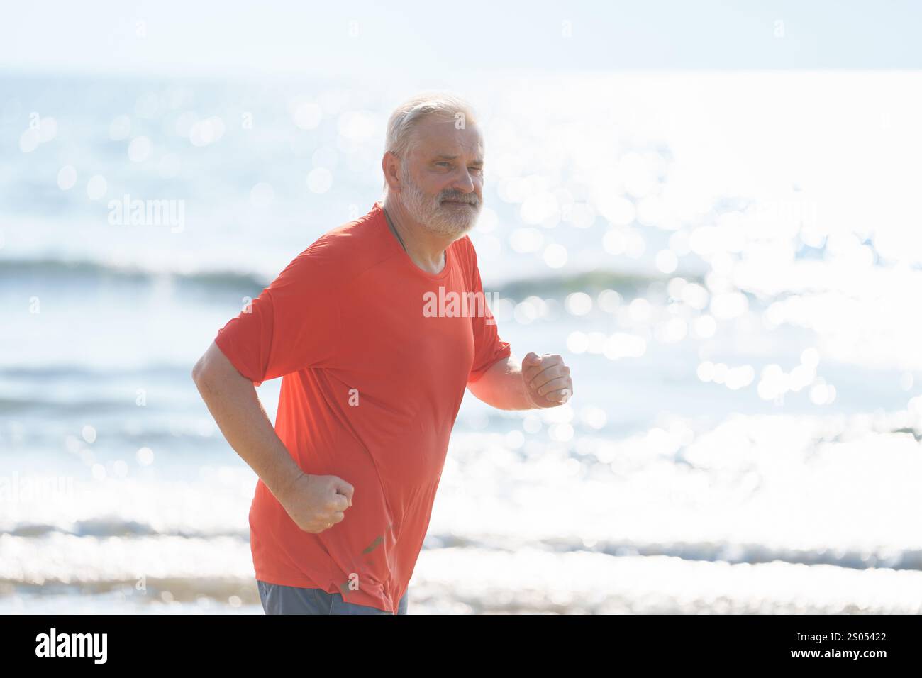 Senior man running on tropical beach. Happy active retirement. Fit ...