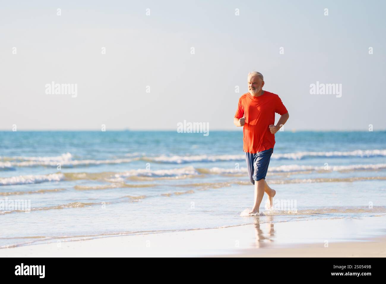 Senior man running on tropical beach. Happy active retirement. Fit ...