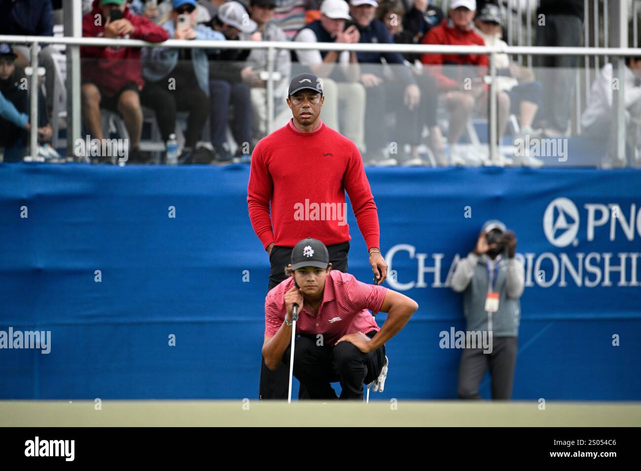 Tiger Woods and his son Charlie Woods, front, line up their putt on the ...