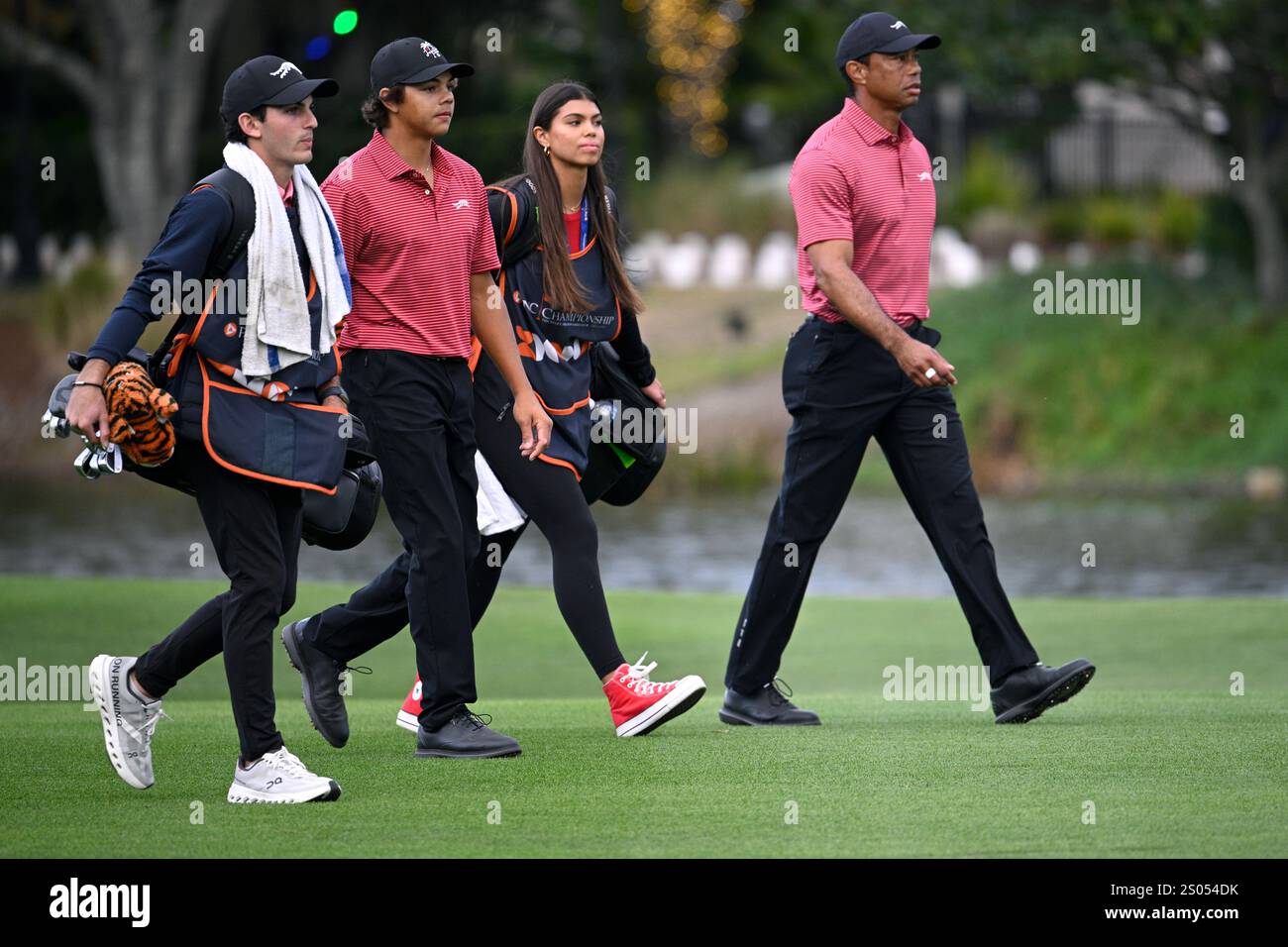 Tiger Woods, right, walks on the 18th fairway with his daughter Sam ...