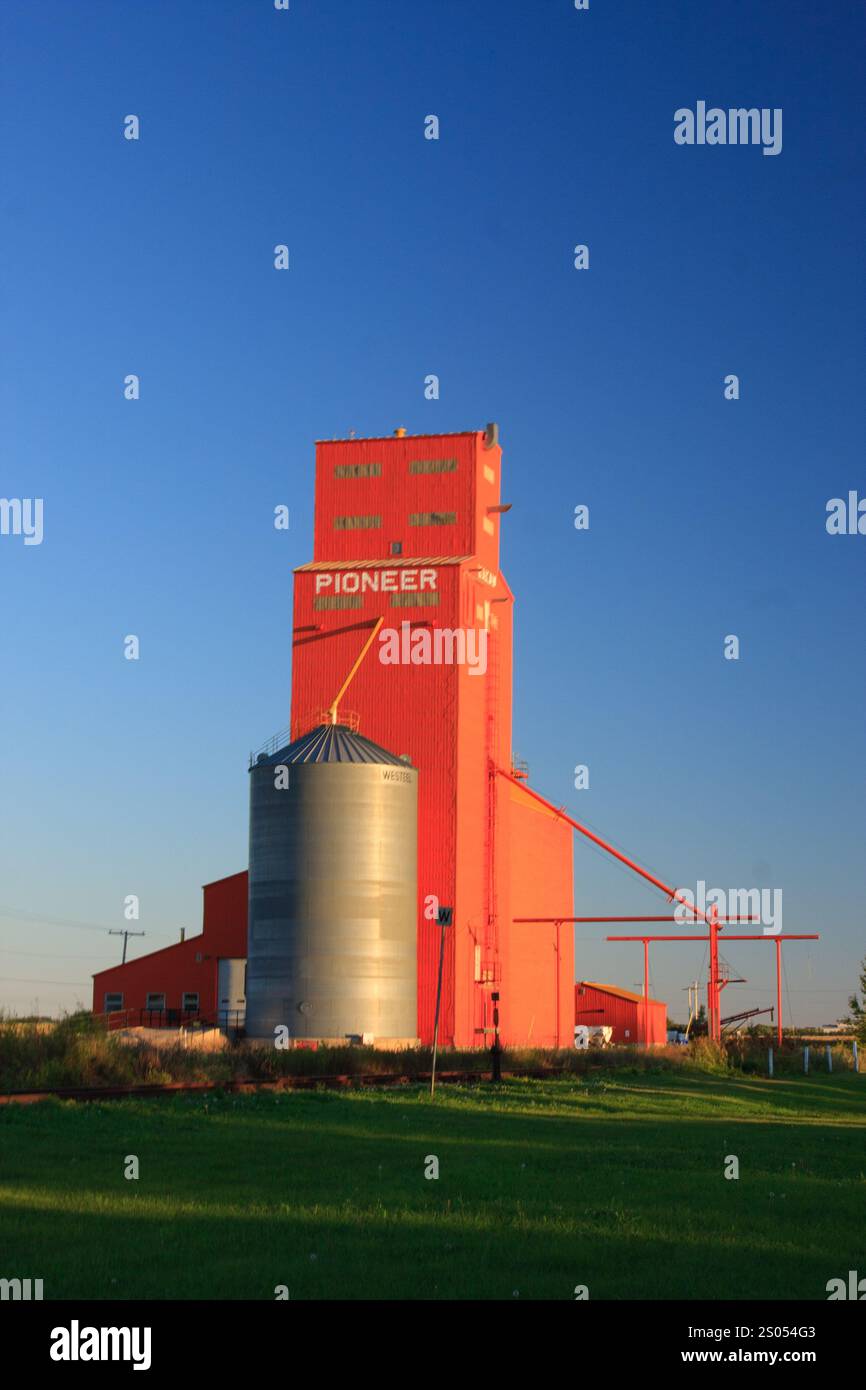 A red grain silo with the word Pioneer on it. The sky is blue and the ...