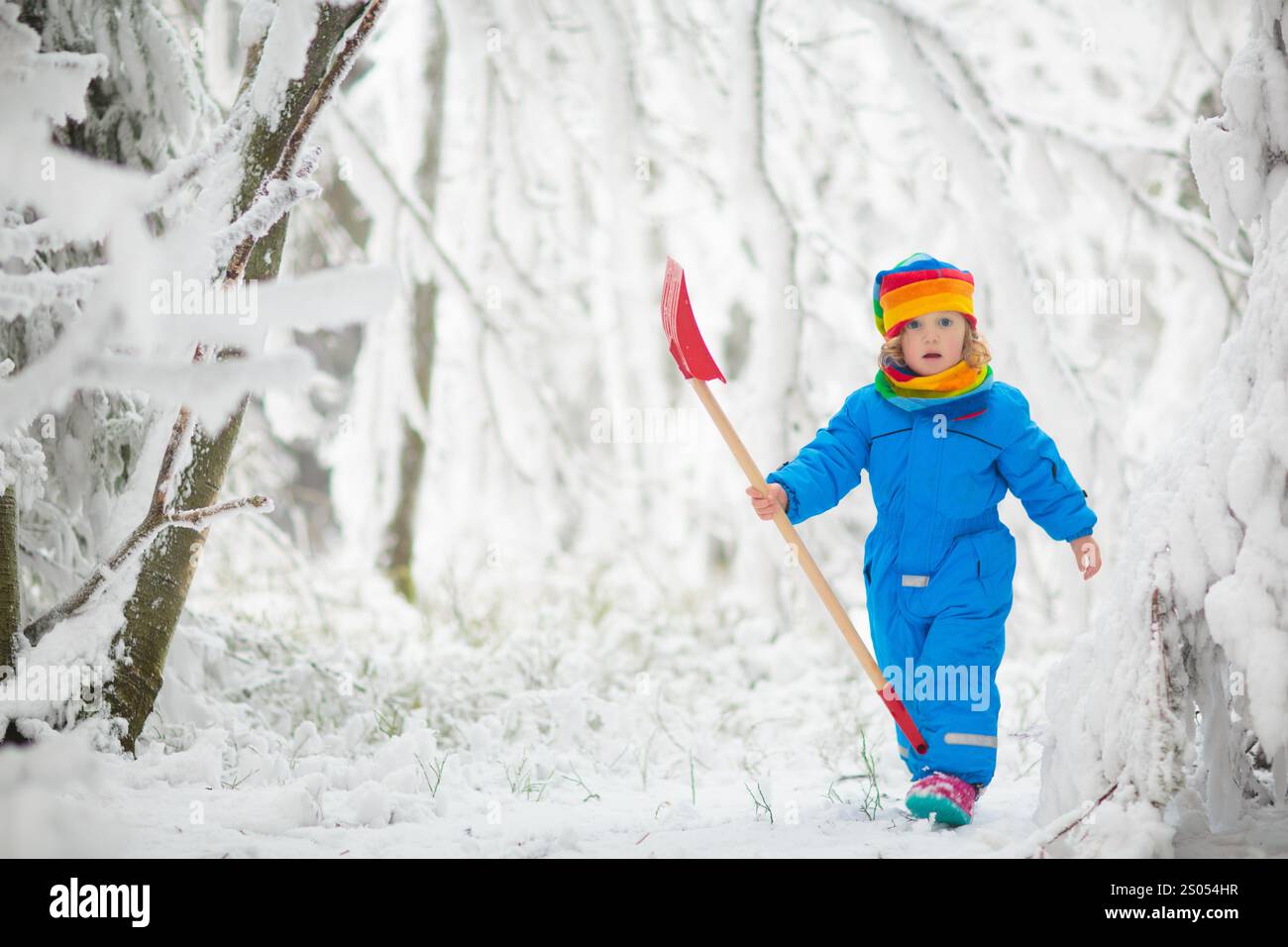 Kids play in snow in winter park. Children playing outdoors on snowy ...