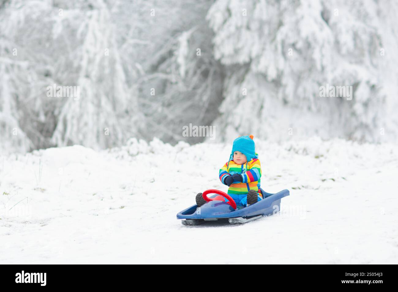 Kids play in snow in winter park. Children playing outdoors on snowy ...