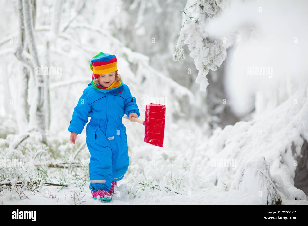 Kids play in snow in winter park. Children playing outdoors on snowy ...