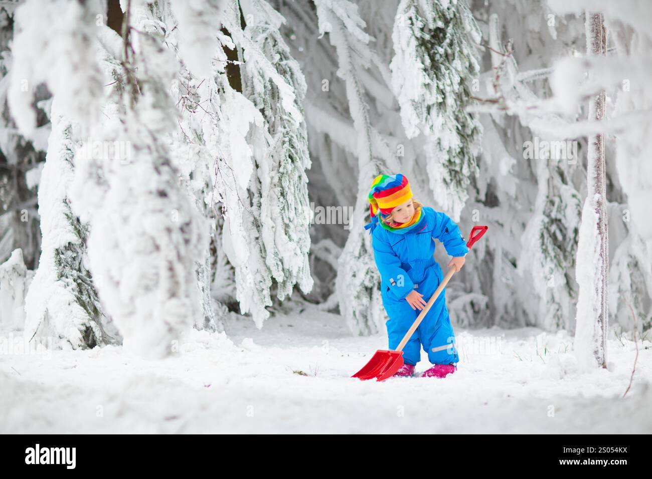 Kids play in snow in winter park. Children playing outdoors on snowy ...