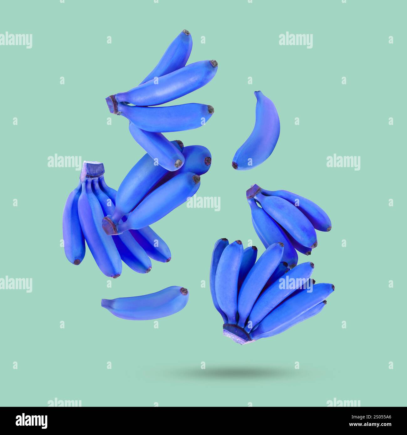 Blue violet bananas in air on light turquoise background Stock Photo ...