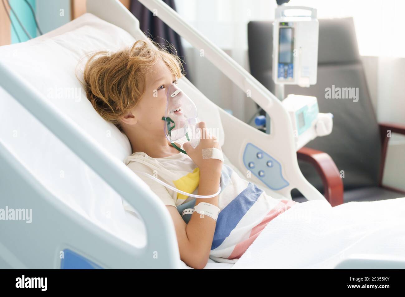 Sick child in hospital room. Kid in clinic ward. Little boy with oxygen ...