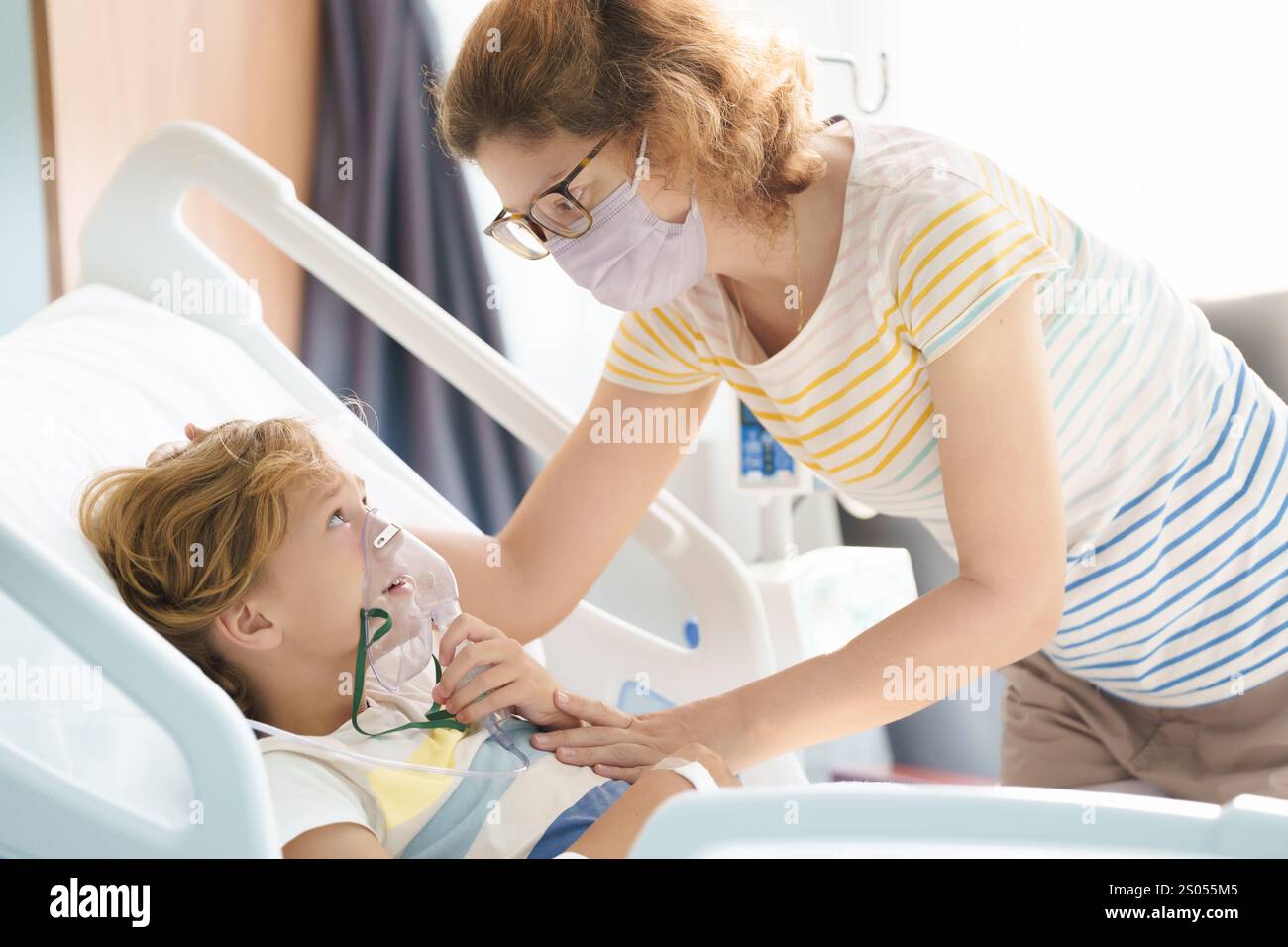 Sick child in hospital room. Kid in clinic ward. Little boy with oxygen ...