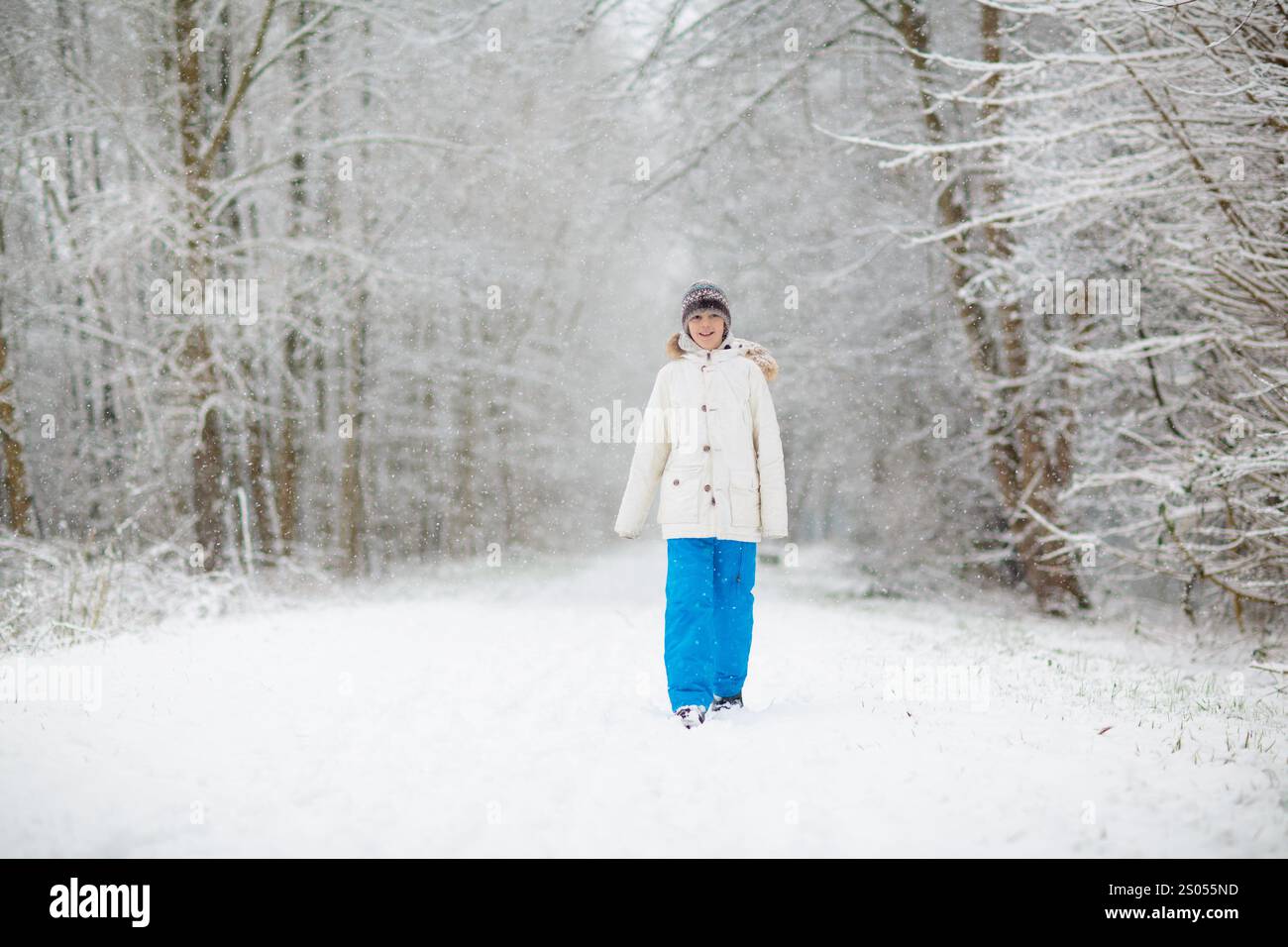 Kids play in snow in winter park. Children playing outdoors on snowy ...